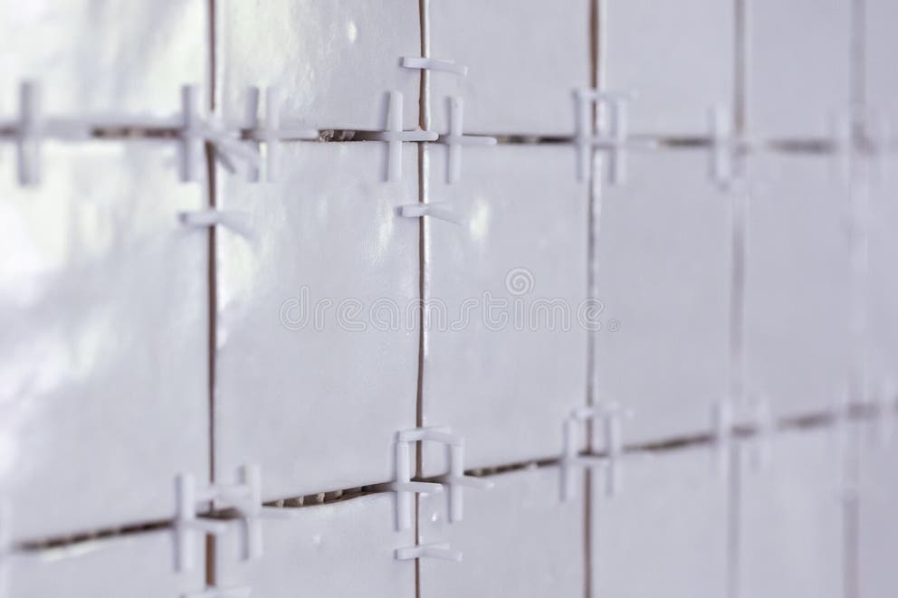 A Close Up of a Tile Wall Under Construction. the Wall is Being Tiled ...