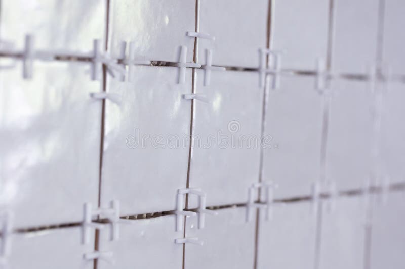 A Close Up of a Tile Wall Under Construction. the Wall is Being Tiled ...