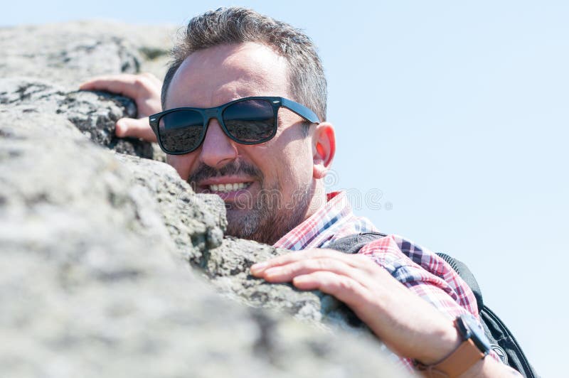 Close-up of Tired Man Climbing a Rock Stock Image - Image of male ...