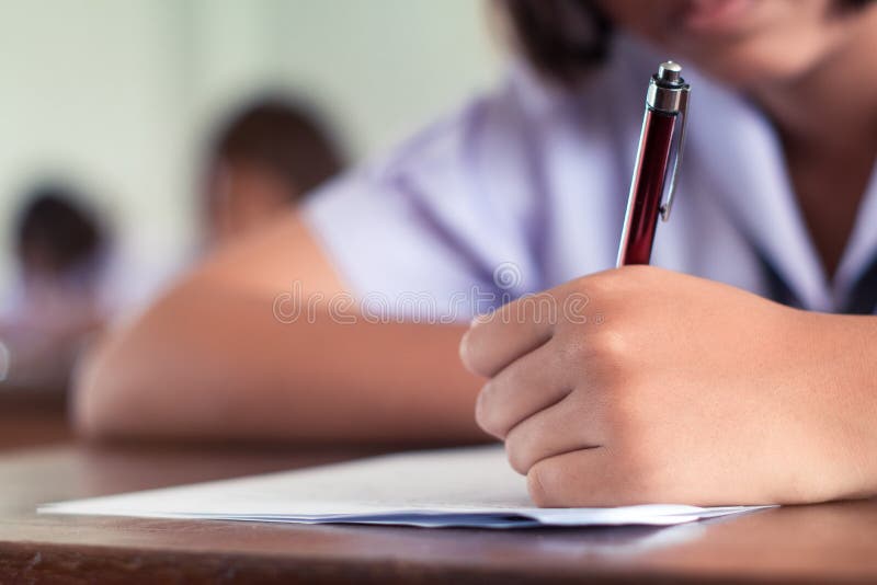 Close Up To Hand of Student is Taking Exam and Writing Answer in ...