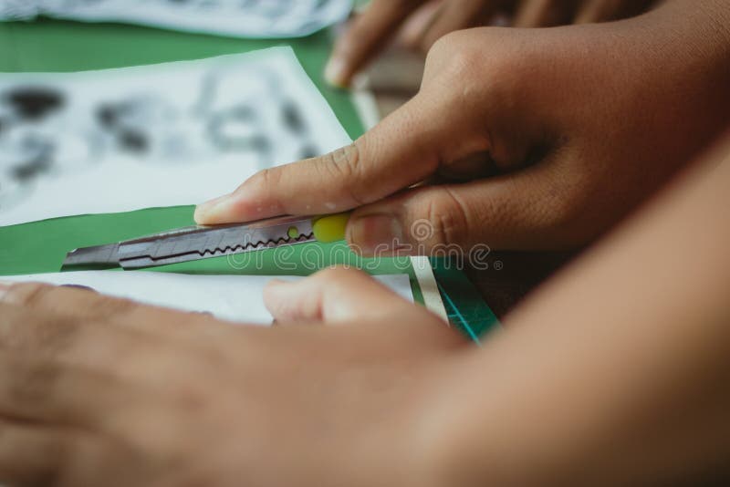 Close-up To Hands of Students are Cutting Prints and Stickers Stock ...