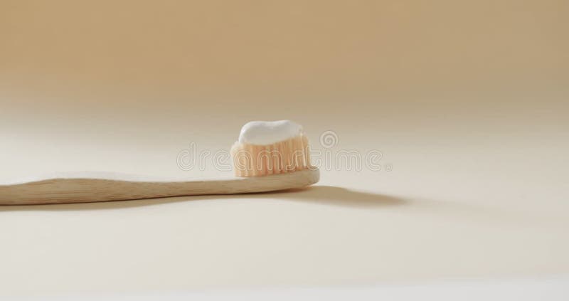 Close Up of Toothbrush with Toothpaste on Beige Background Stock Video ...