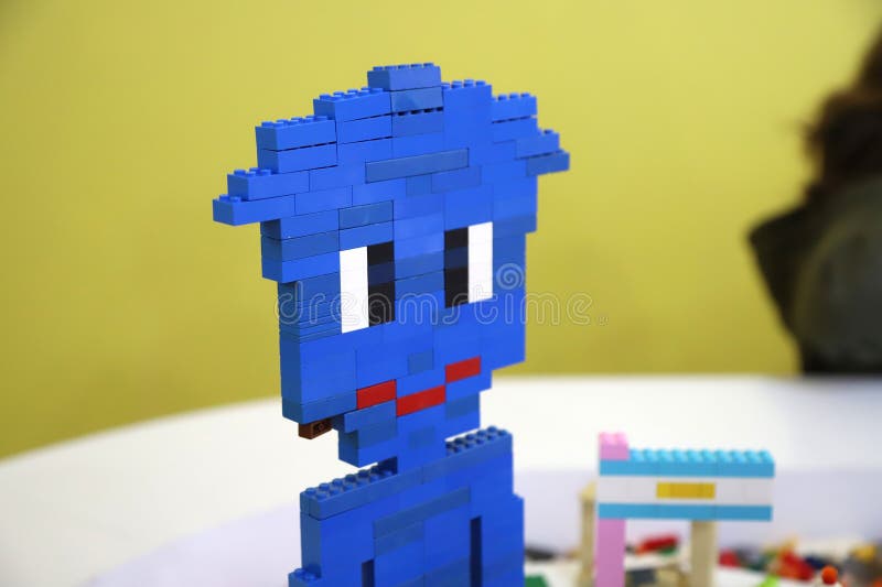Close-up of a Toy Boy Figure Armed with Blue Plastic Building Blocks ...
