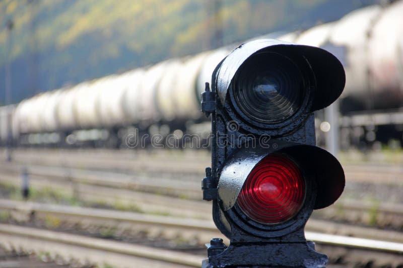 Close-up of a Traffic Light Against the Backdrop of a Standing Freight ...