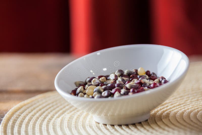 Close Up of Tri Color Popcorn Kernels in a White Bowl with Selective ...