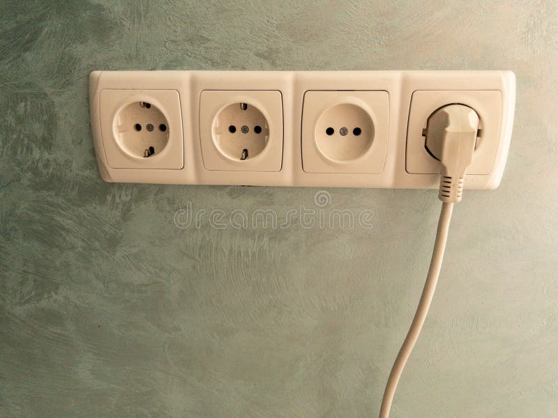 Close-up of a Triple Wall Power Socket, with One Outlet in Use and a ...