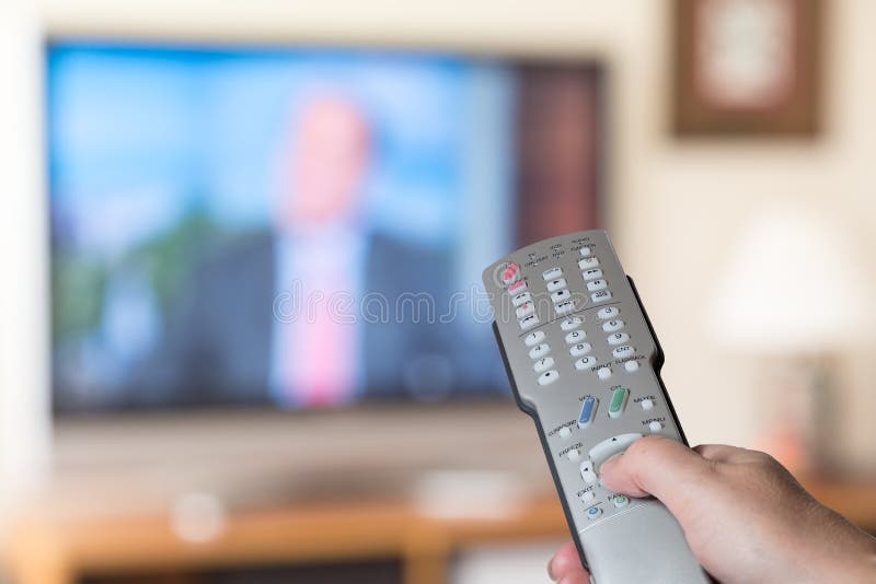 Watching Television in Modern TV Room. Hand Holding Remote Stock Photo ...