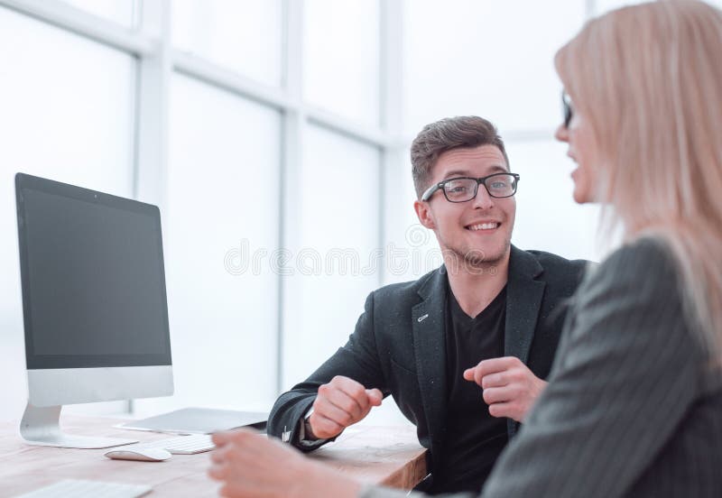 Two Business Colleagues Discussing a Work Project at the Desktop Stock ...