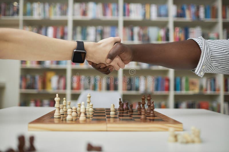 Close Up of Two Chess Players Shaking Hands Over Chess Board after ...