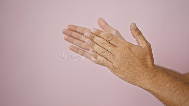 Close-up of Two Clapping Hands Against a Soft Pink Background ...