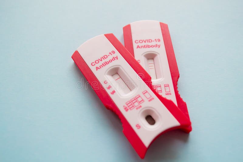 Close-up of Two Covid-19 Tests: One Negative, One Positive. Blue ...