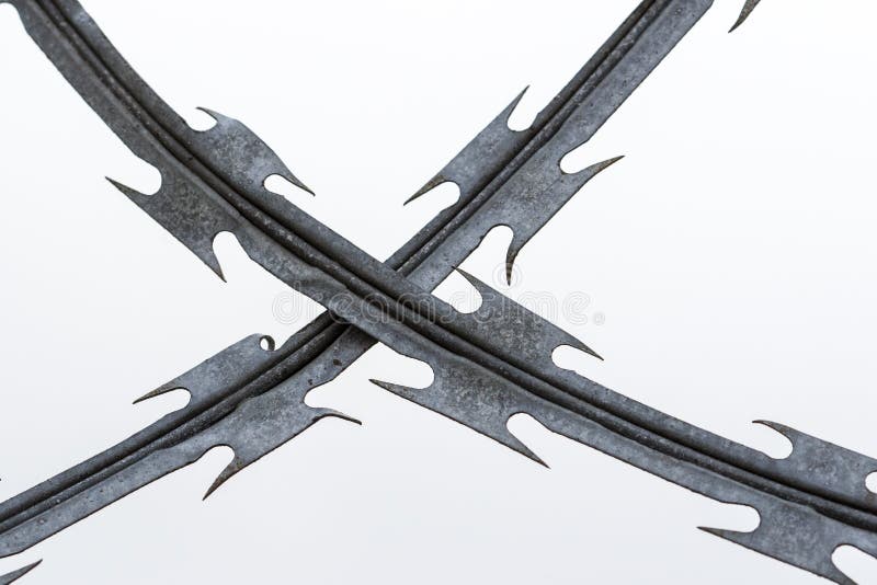 Close Up of Two Crossed Pieces of Razor Wire Stock Image - Image of ...
