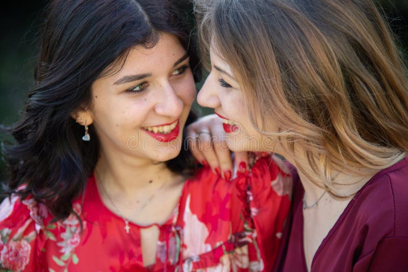 Close Up Of Two Lesbian Friends With Their Cheeks Resting One Blonde