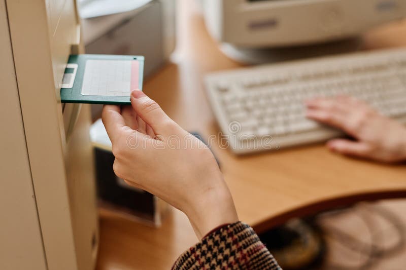 Inserting Floppy Disk into Drive in Office Setting Stock Image - Image ...