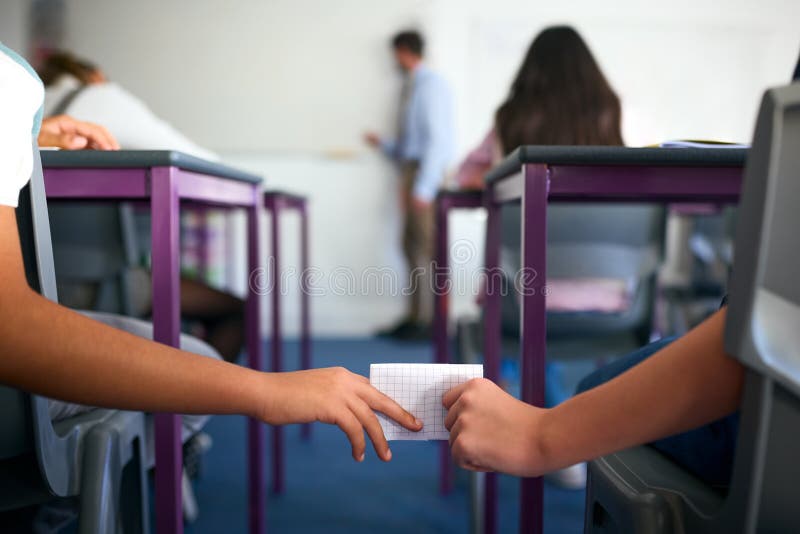 Close Up of Two Male Secondary or High School Pupils Passing Note ...