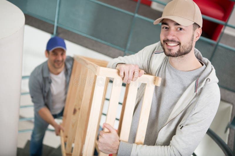 Close-up Two Men Carrying Wooden Shelf Stock Image - Image of team ...