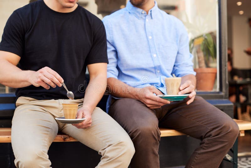 Close Up of Two Men Sitting Outside Coffee Shop Drinking Coffee Stock ...