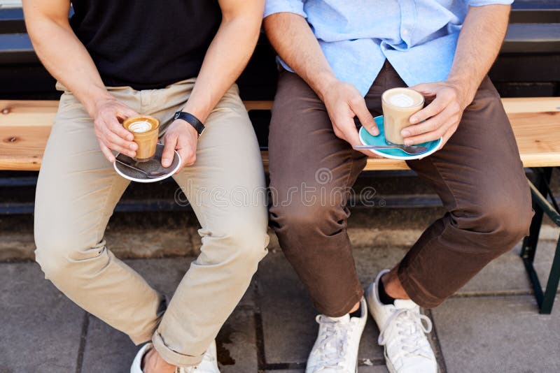 Close Up of Two Men Sitting Outside Coffee Shop Drinking Coffee Stock ...