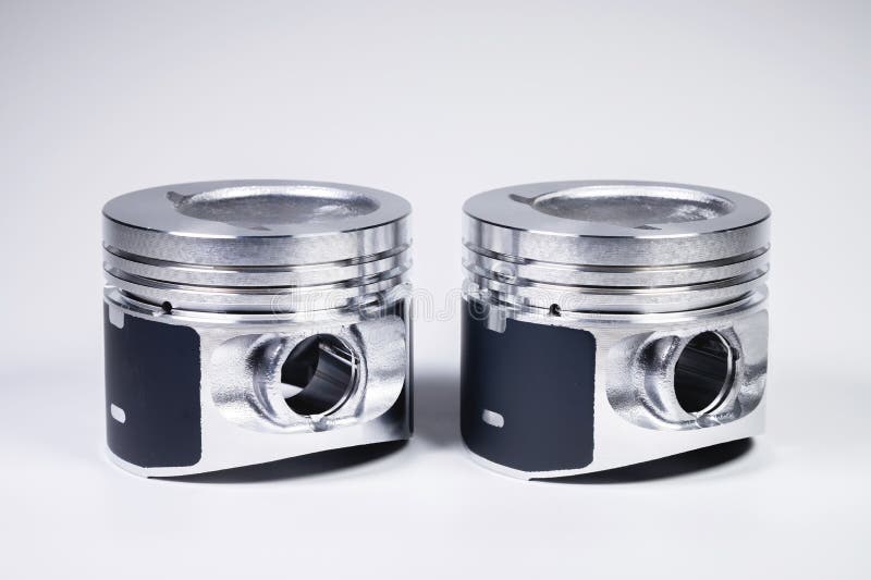 Close-up Of Two New Internal Combustion Engine Piston On A Gray ... Close-up Of Two New Internal Combustion Engine Piston On A Gray ...