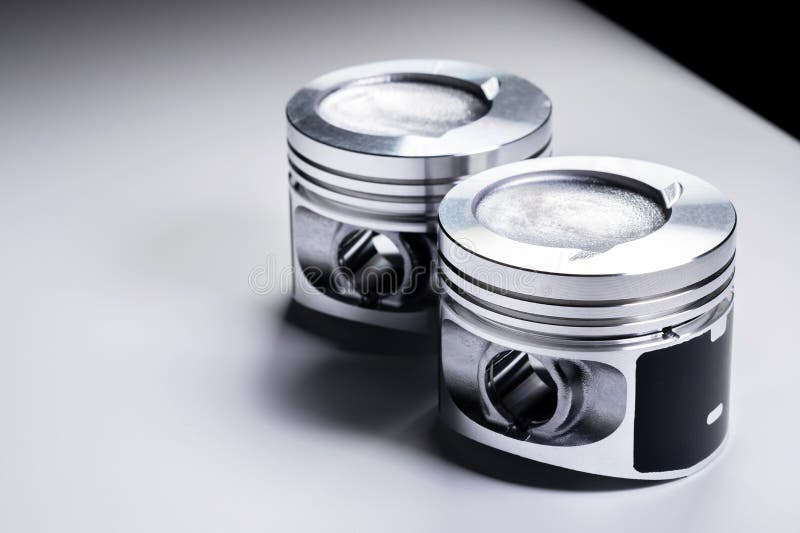 Close-up of Two New Internal Combustion Engine Piston on a Gray ... Close-up of Two New Internal Combustion Engine Piston on a Gray ...