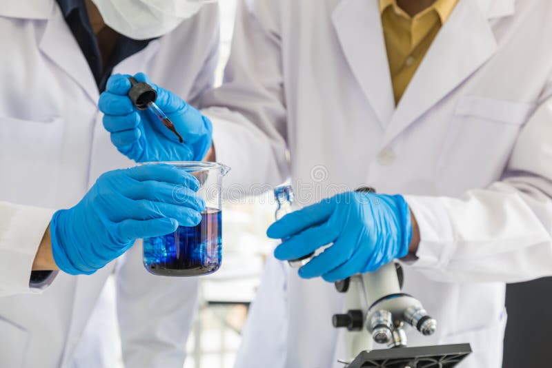 Close Up of Two Professional Doctor Scientist Using Dropper To Test and ...