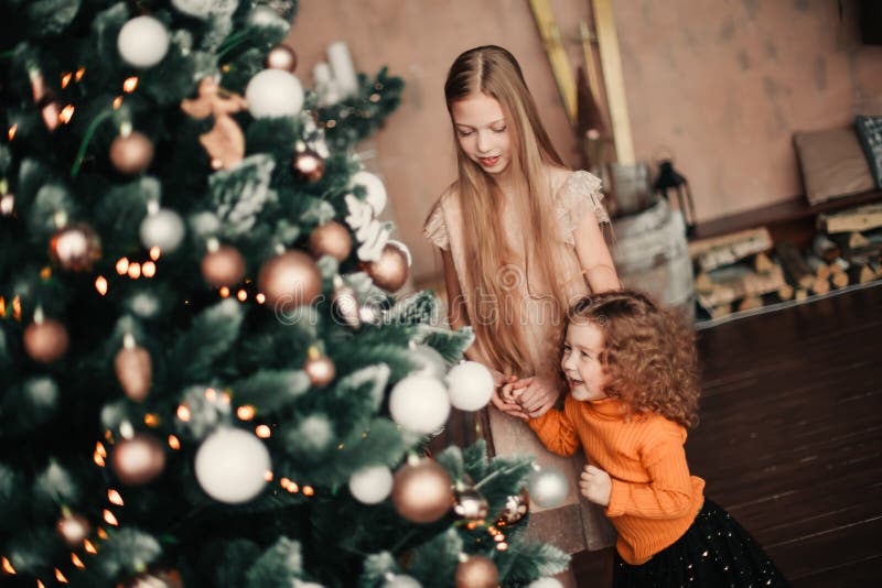 Close Up.two Sisters Standing by the Christmas Tree Stock Photo - Image ...