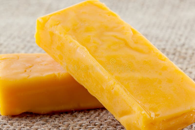 A Close Up of Two Small Cheddar Cheese Pieces. Stock Photo - Image of ...