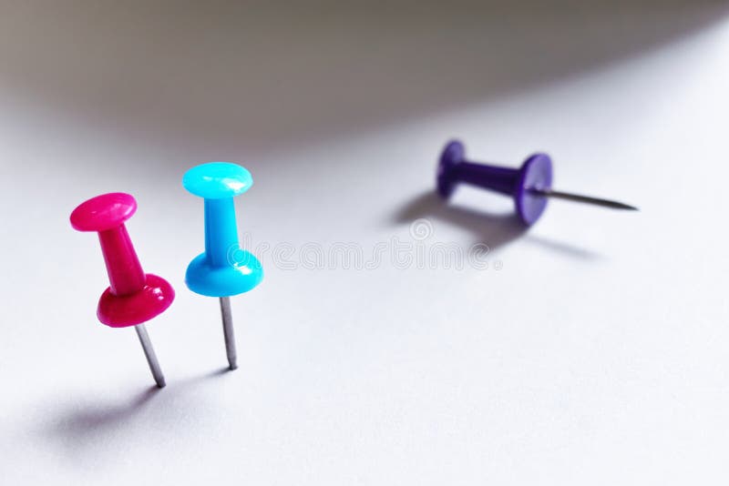 Close-up of Two Standing Colored Push Pins and One Overturned Pin Stock ...