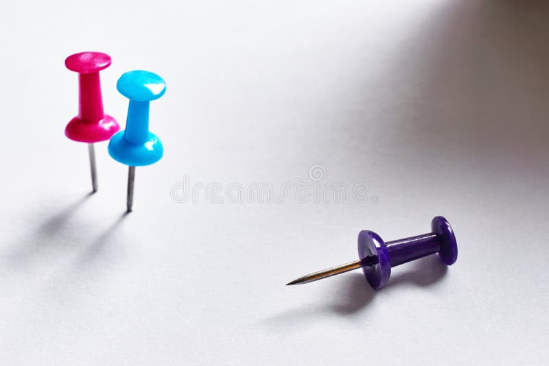 Close-up of Two Standing Colored Push Pins and One Overturned Pin Stock ...