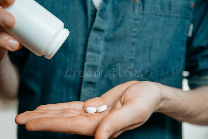 Close Up. Two Tablets in the Palm of a Person`s Hand Stock Photo ...