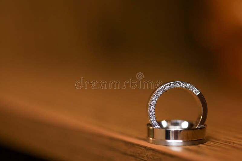 Close Up of Two Wedding Rings on Flat Wooden Surface Stock Image ...