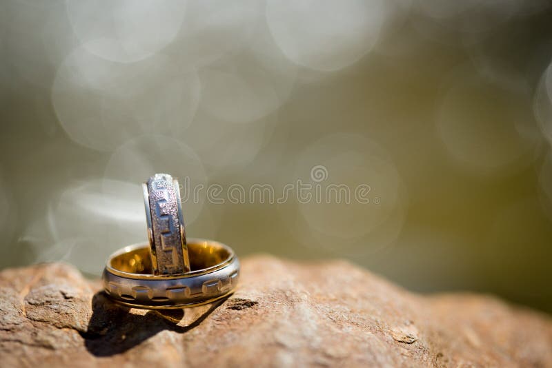 Close Up of Two Wedding Rings on Rock Stock Image - Image of background ...
