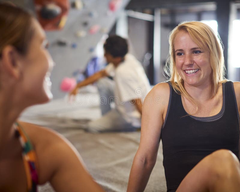 Close Up of Two Women Taking a Break and Talking by Climbing Wall in ...