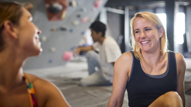Close Up of Two Women Taking a Break and Talking by Climbing Wall in ...