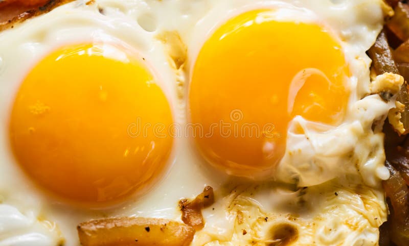 Close-up of Two Yellow Soft Fried Eggs on Roasted Onions, Bachelor Meal ...