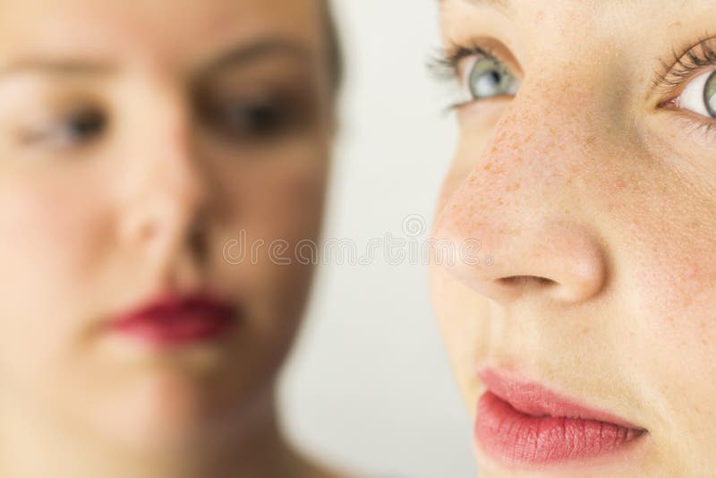 Close Up of Two Young Girls Faces Stock Image - Image of face, green ...