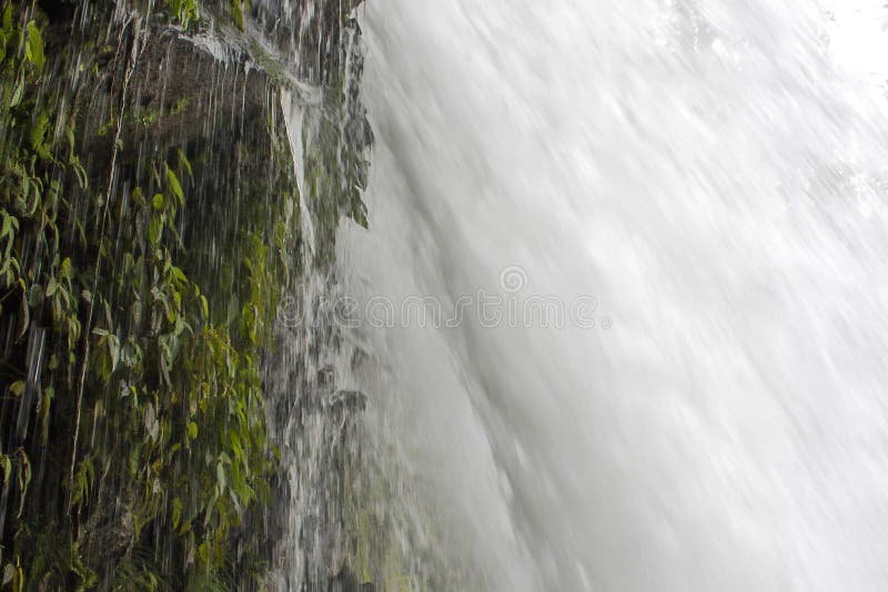Close Up Underneath Waterfall with Dripping Green Cliffside Stock Image ...