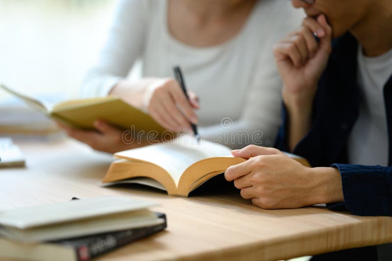Close Up of University Students Working Together on Academic Project in ...