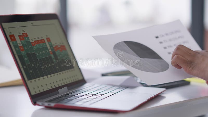 Close-up of Unrecognizable Man Comparing Paper Business Graph with Data ...