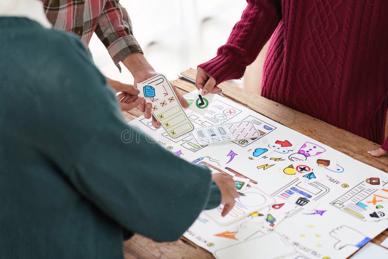 Close Up Ux Developer and Ui Designer Brainstorming Interface Wireframe ... Close Up Ux Developer and Ui Designer Brainstorming Interface Wireframe ...