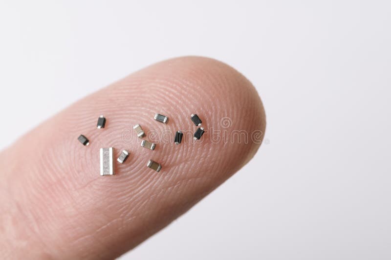 Close Up of Various Electronic Microchips on Human Finger Stock Photo ...