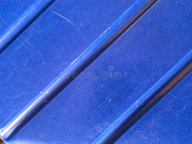 A Close-up of a Vibrant Blue Textured Surface with Parallel Raised ...