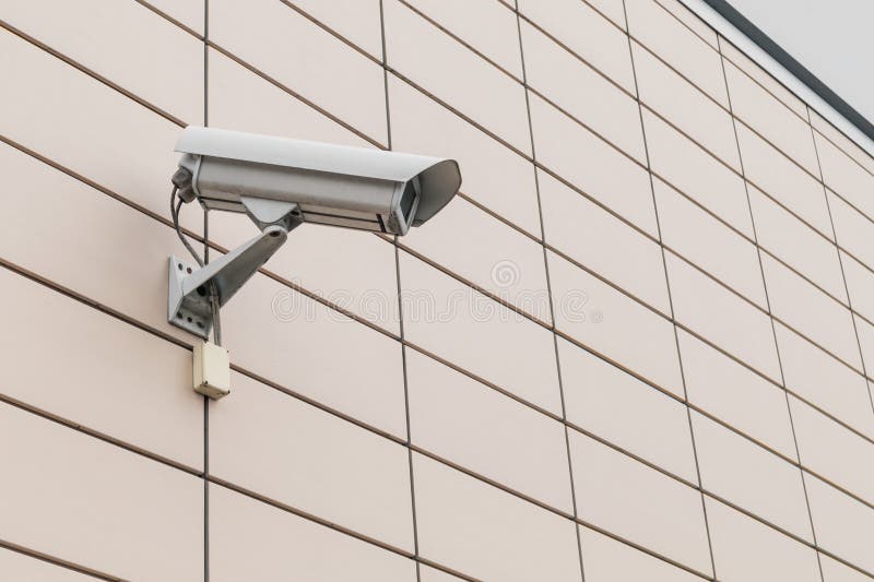 Close-up Video Surveillance Camera on a Bright Building Wall Stock ...