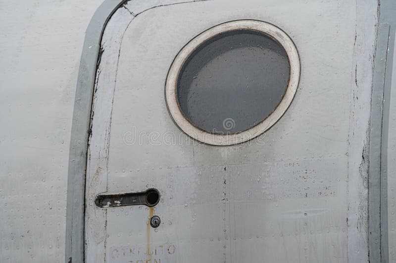 Close-up View of an Aged Airplane Side, Featuring a Porthole Window ...