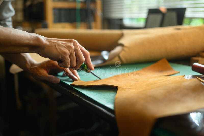 Close Up View of Artisan Working on a Piece of Leather on Cutting Mat ...