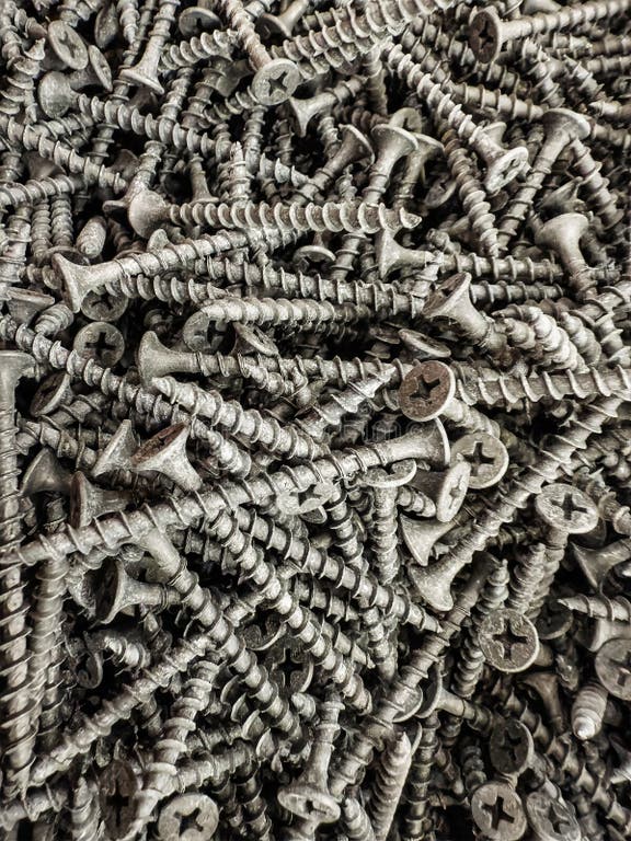 Close-up View of Assorted Screws Scattered on a Surface in a Workshop ...