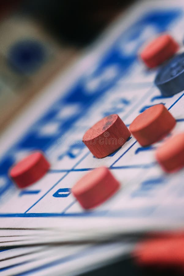 Close-up View of a Bingo Card and Red Markers during a Game Session ...