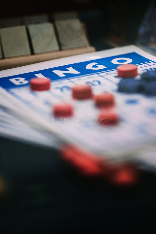 Close-up View of a Bingo Card and Red Markers during a Game Session ...