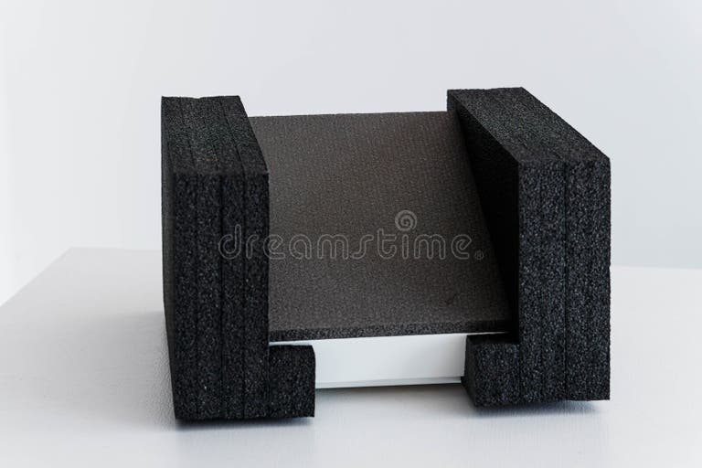 Close Up View of Black Protective Foam Packaging Securing White Object ...