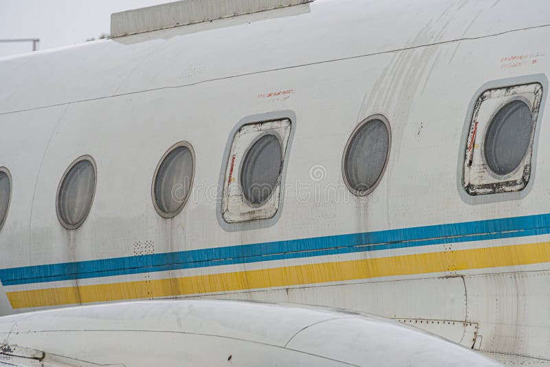 Close-up View of a Blue and Yellow Airplane with Visible Windows, Two ...